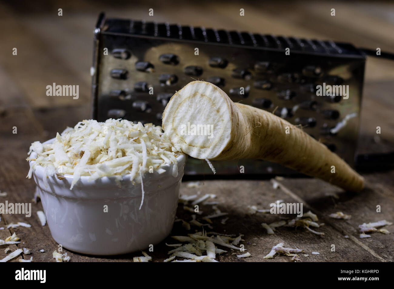 Root of parsley root on grater. Grate and parsley on the old kitchen ...