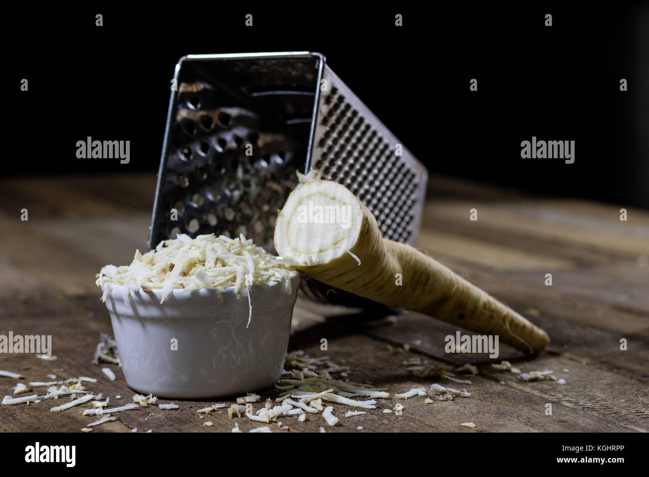 Root of parsley root on grater. Grate and parsley on the old kitchen ...