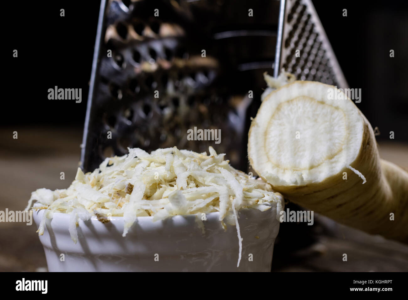 Root of parsley root on grater. Grate and parsley on the old kitchen ...