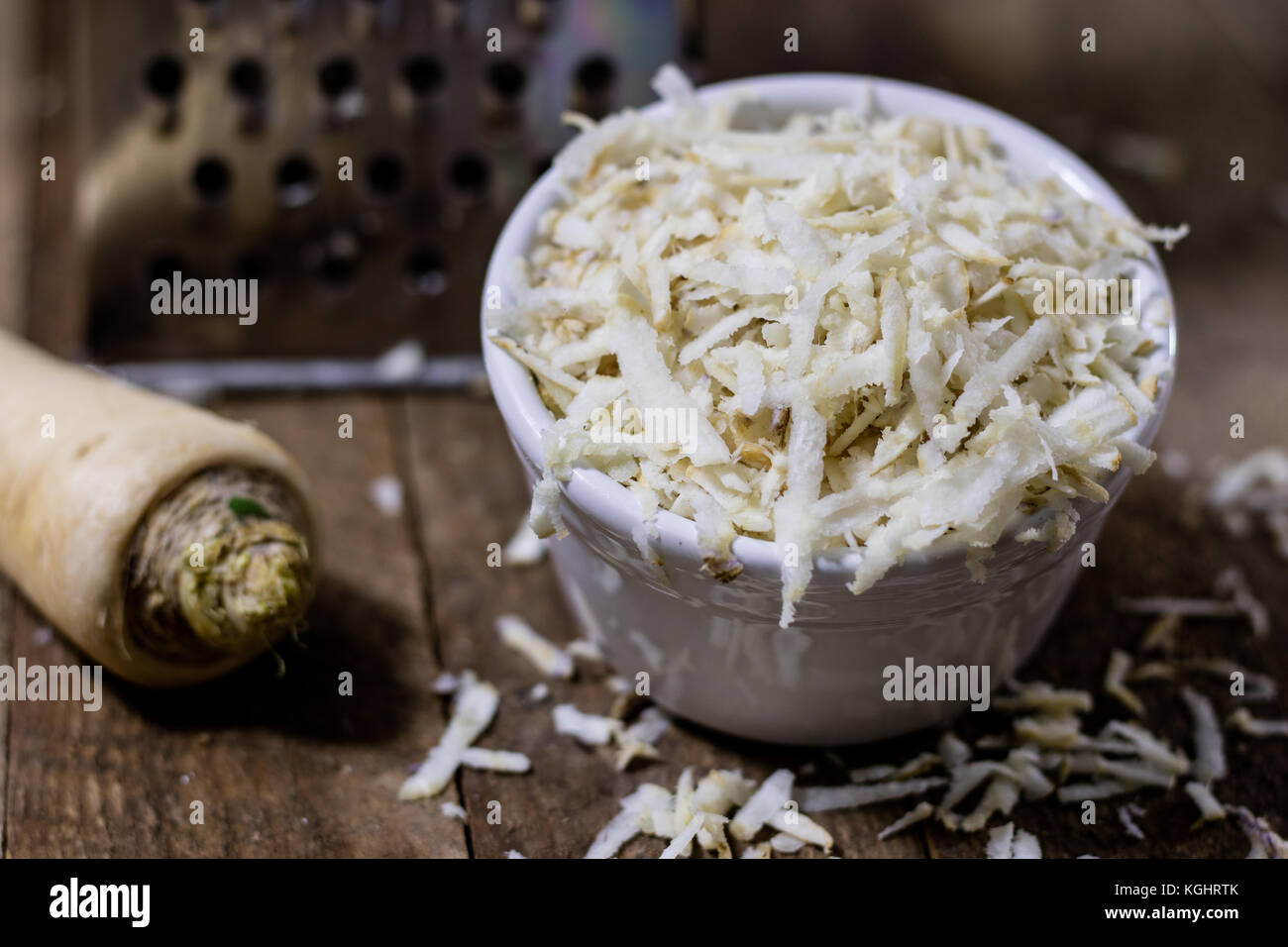 Root of parsley root on grater. Grate and parsley on the old kitchen ...