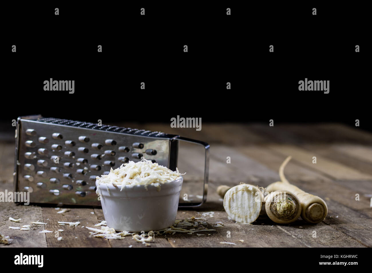 Root of parsley root on grater. Grate and parsley on the old kitchen ...