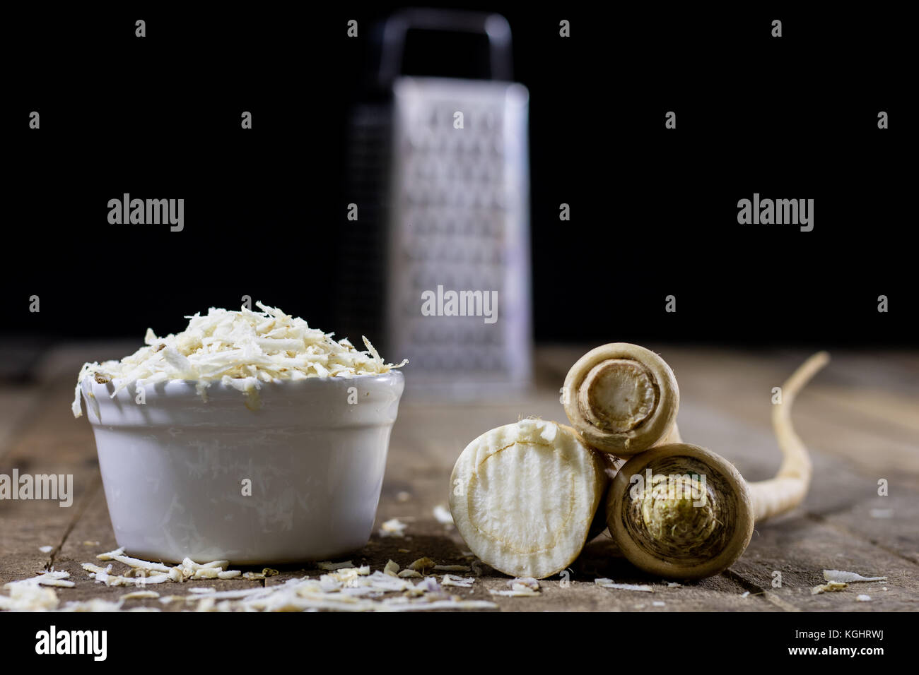 Root of parsley root on grater. Grate and parsley on the old kitchen ...
