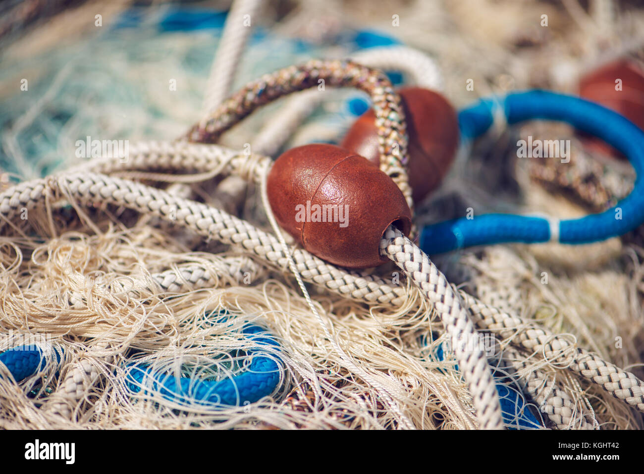 Pile of commercial fishing net with cords and floats as abstract ...