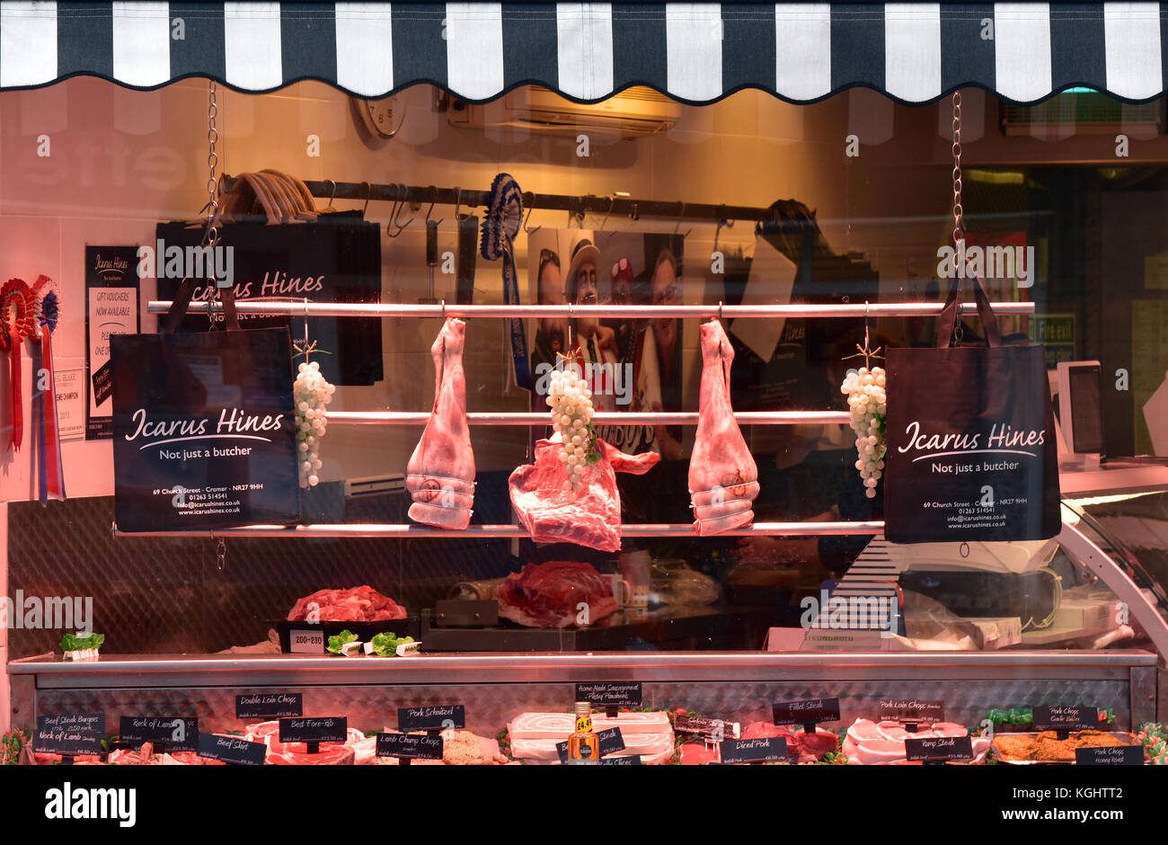 a Norfolk butchers shop window with various different cuts of meat for ...