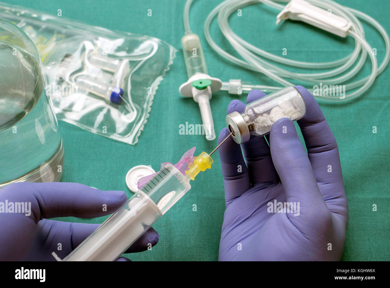 Doctor preparing medication to inject, conceptual image Stock Photo - Alamy