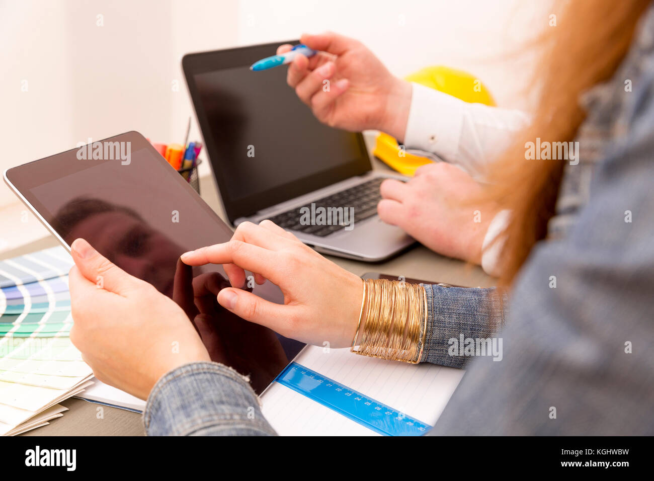 Creative interior design team during brainstorming working on laptop in ...