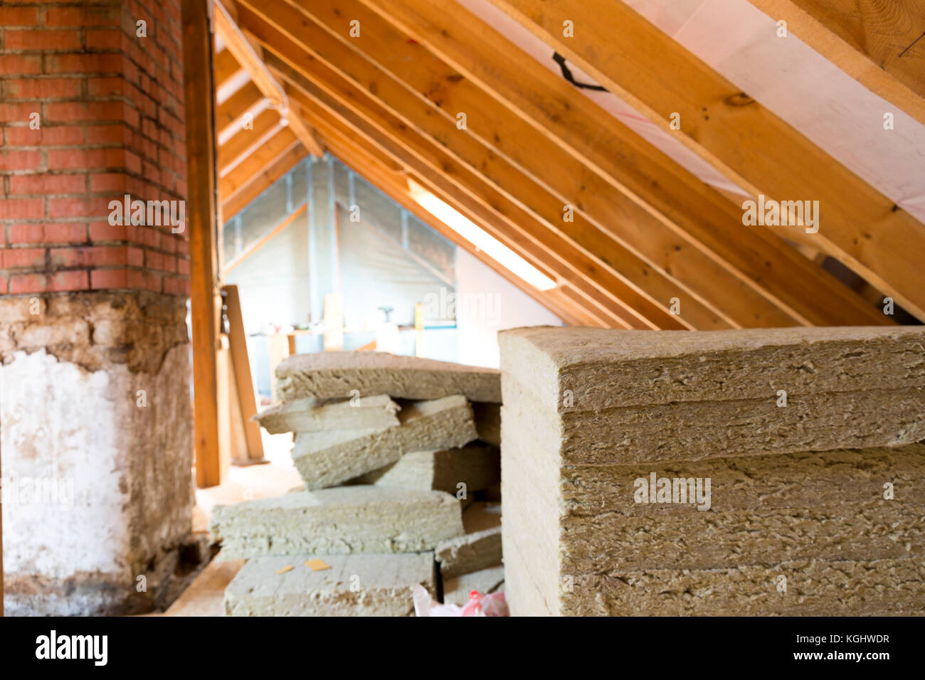 View of attic renovation and construction site with pile of rockwool ...