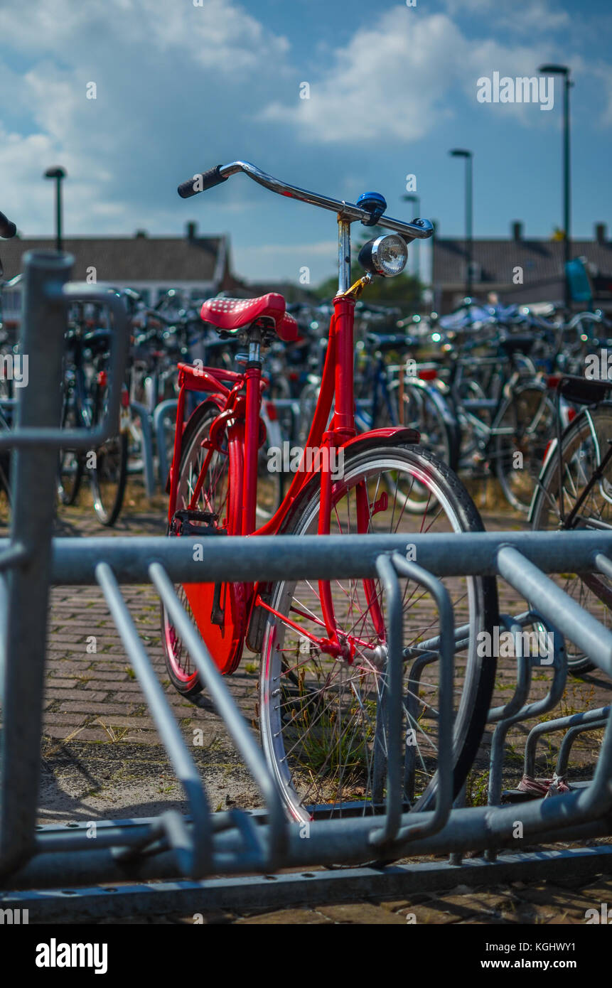 red bike in a bicycle parking rack Stock Photo - Alamy