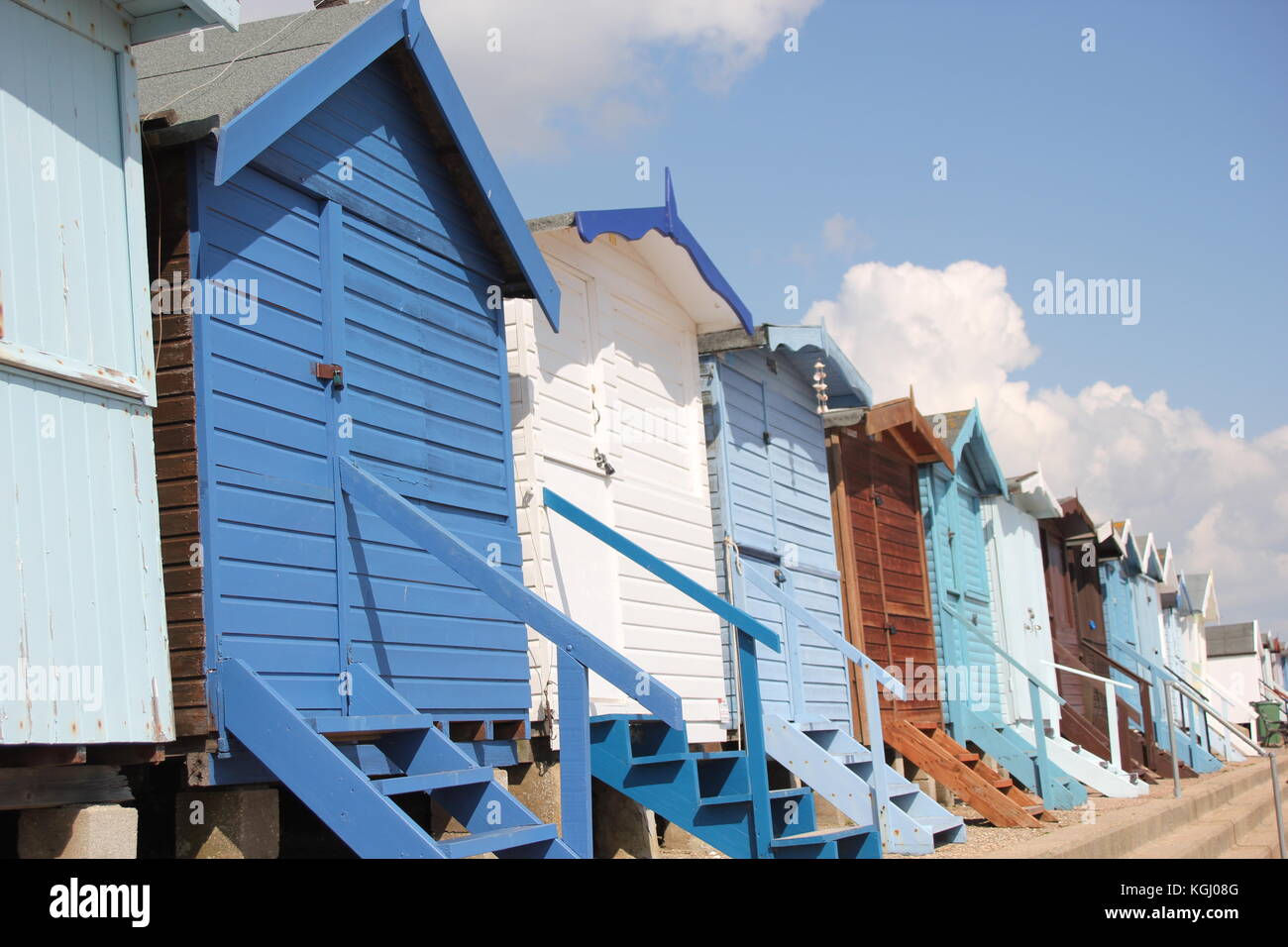 beach hut painted house paint on frinton beach Stock Photo - Alamy