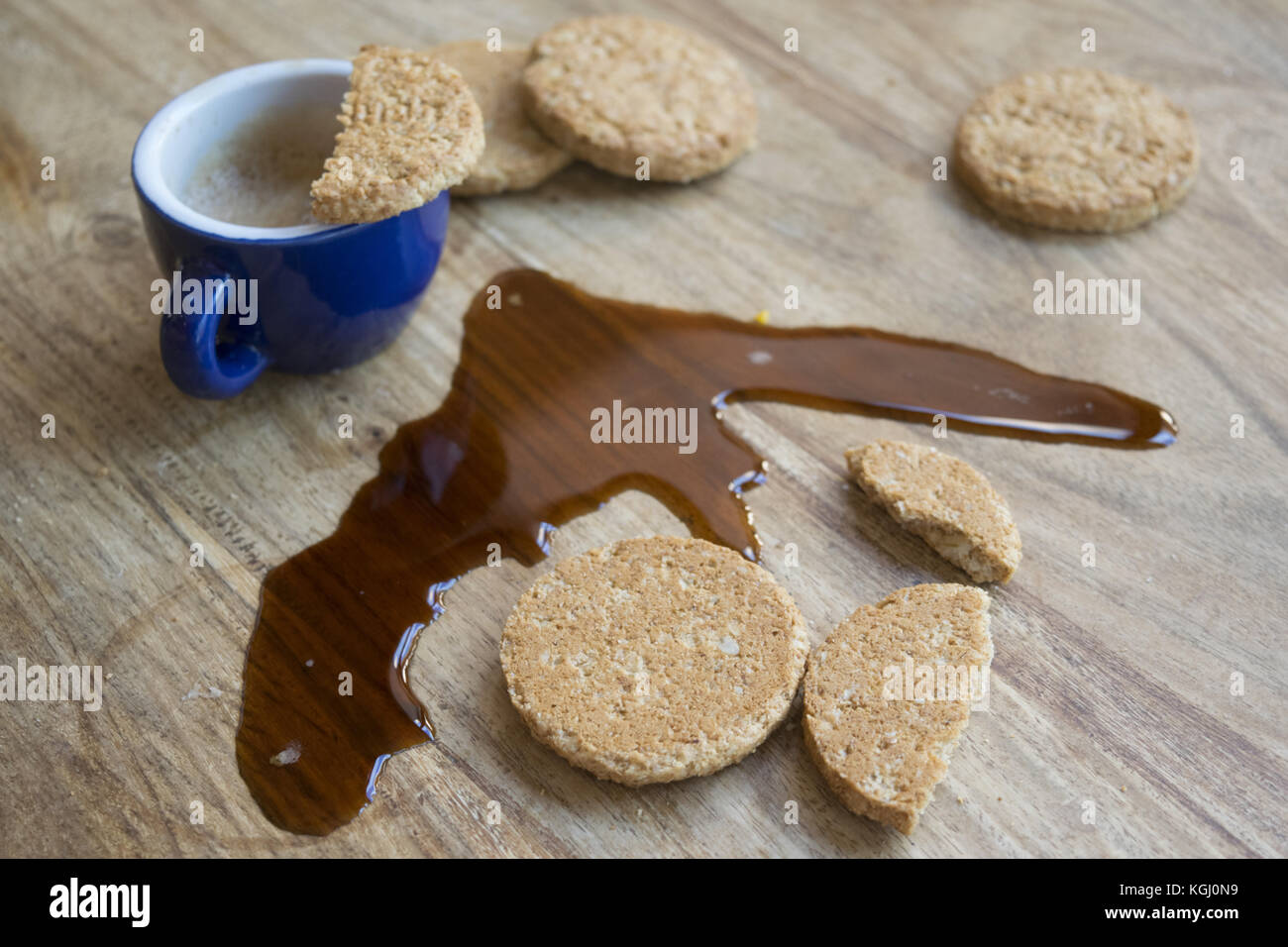 cup of espresso coffee spilled on a wooden table near wholemeal ...