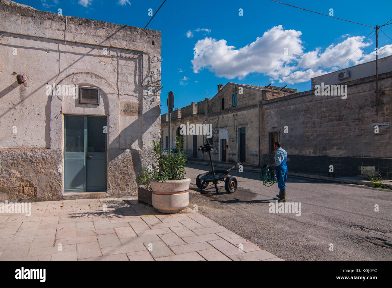 A man works in a street of the village Poggiorsini, Italy. Poggiorsini ...