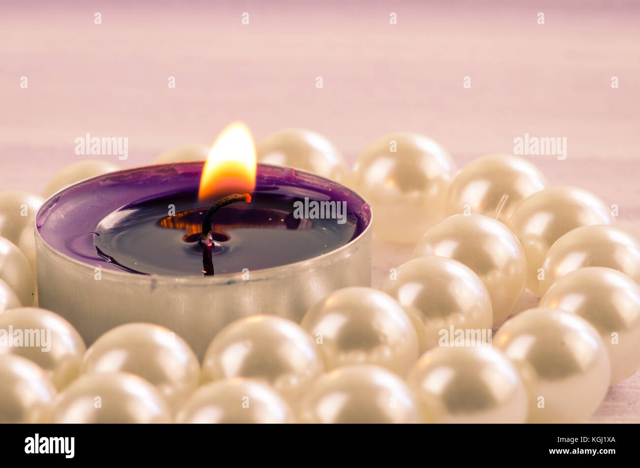 burning candle and white bead decoration Stock Photo - Alamy