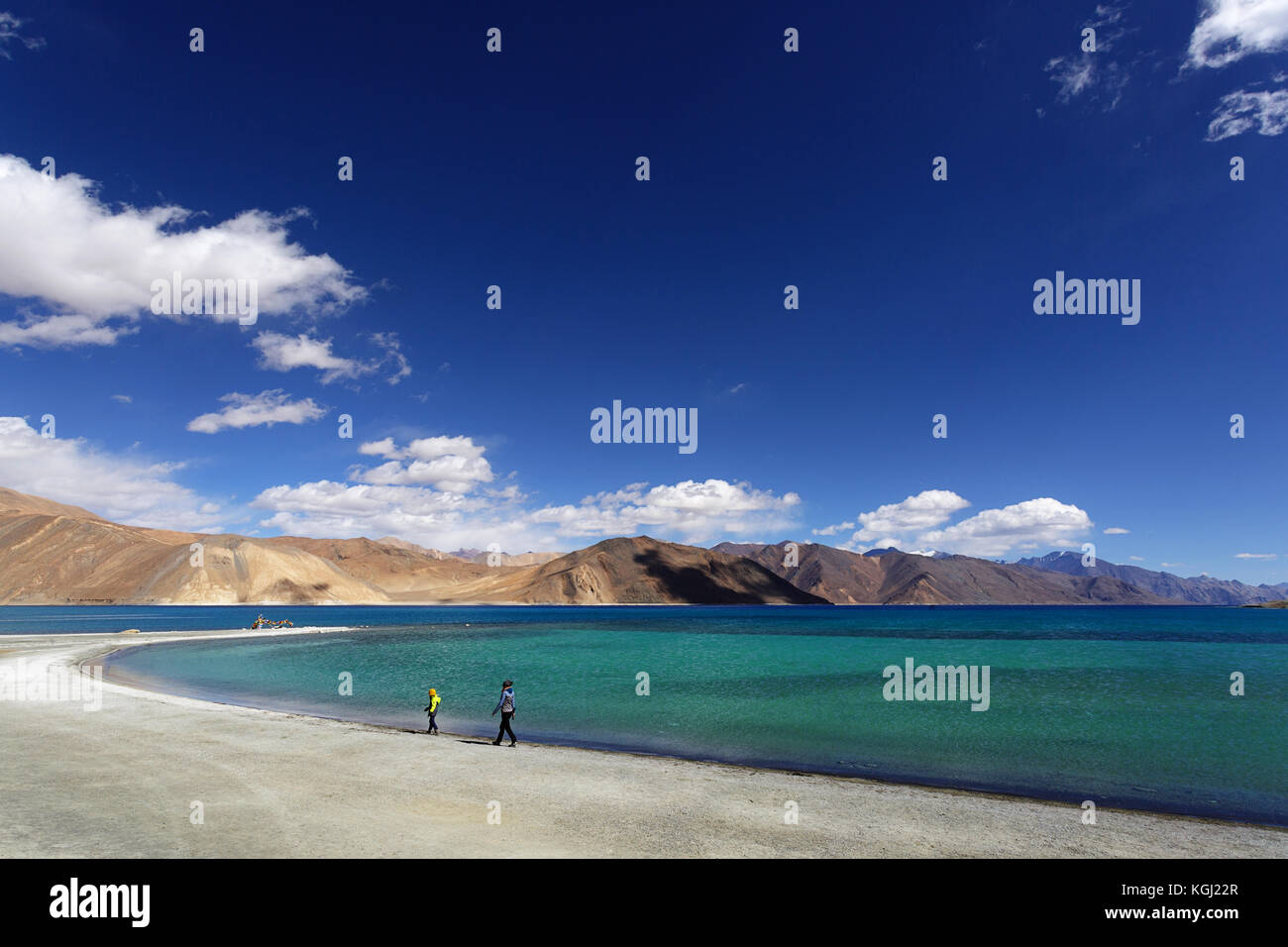 Mother and son walking on the white shores of the beautiful Pangong Tso ...
