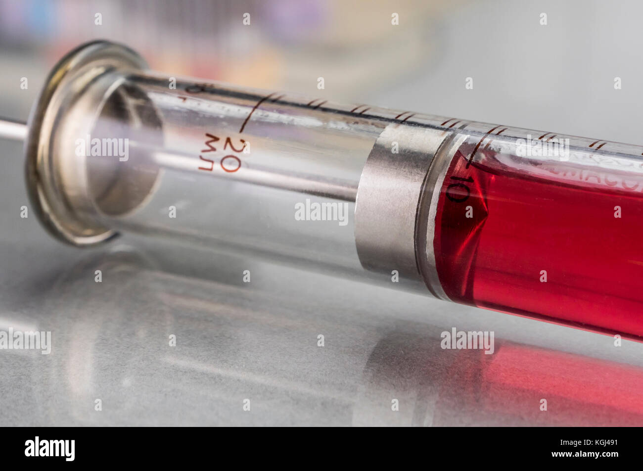 Vintage syringe detail full of blood, conceptual image Stock Photo - Alamy
