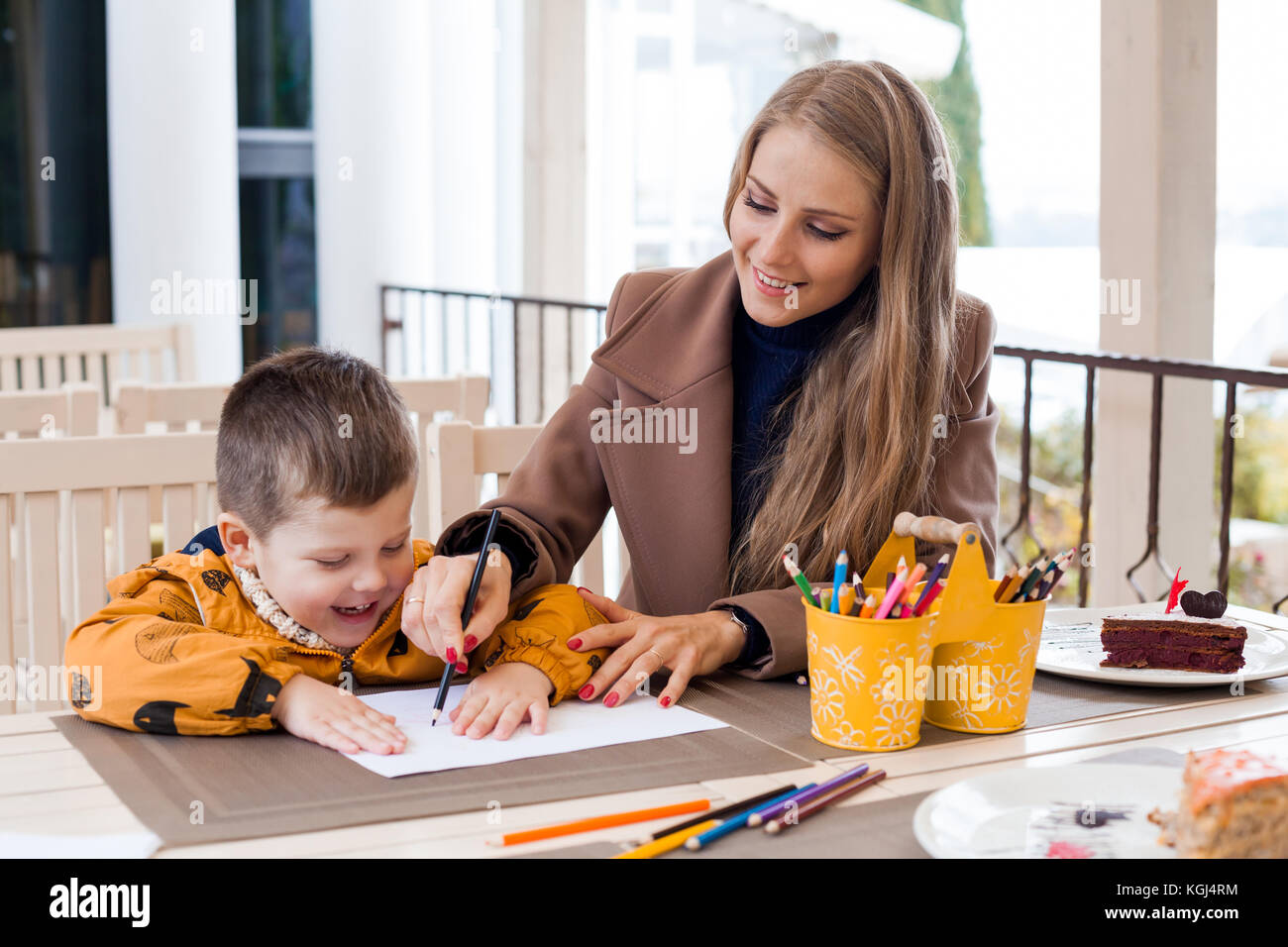 Son drawing together mom helping hi-res stock photography and images ...