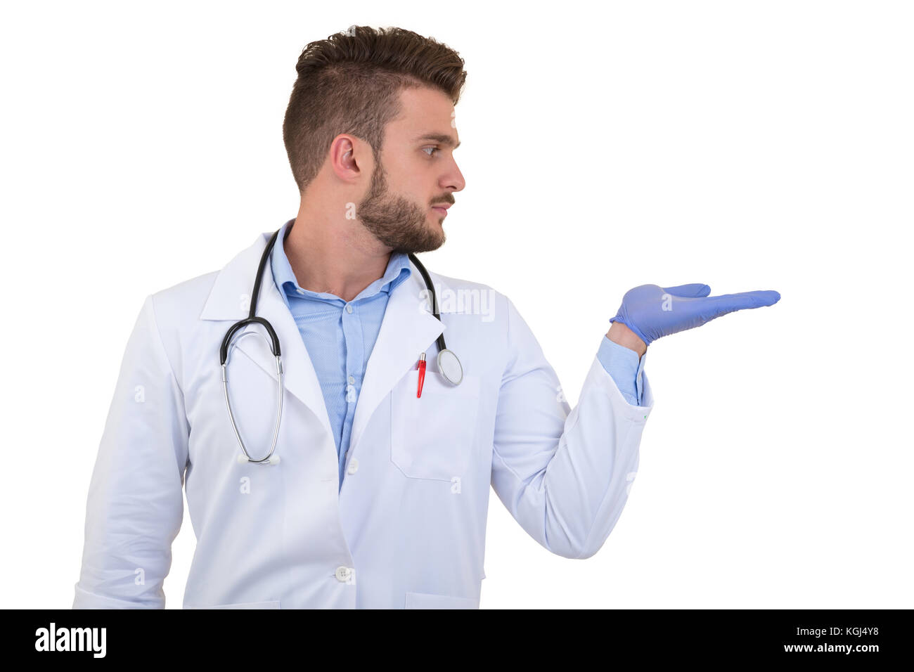Portrait of a smiling male doctor pointing finger away isolated on a ...