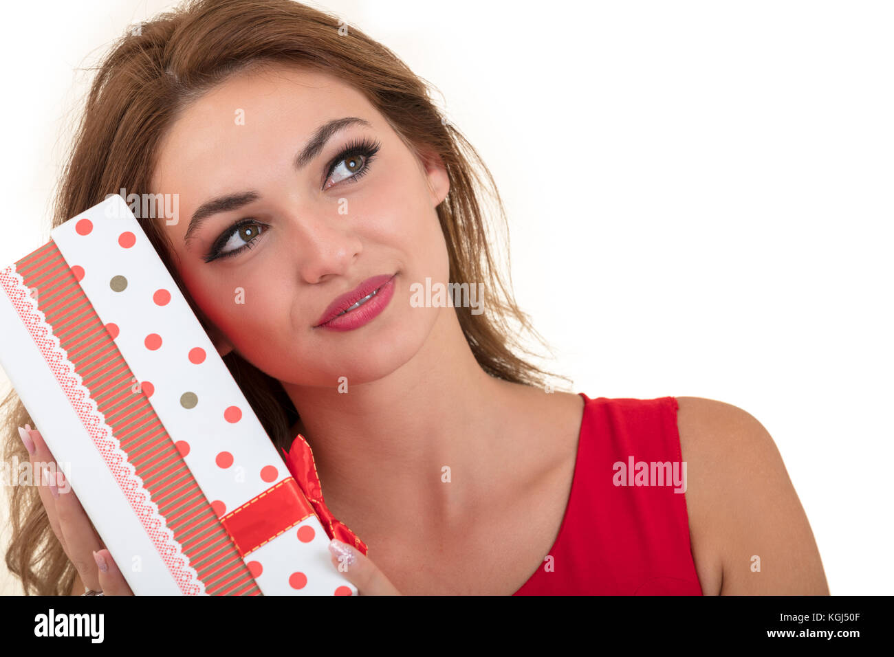 Portrait of casual young happy smiling woman hold red gift box ...