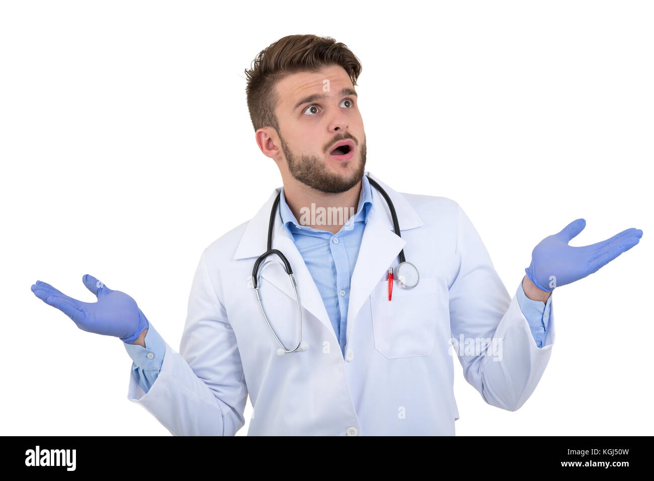 Surprised male doctor posing in a white uniform isolated on white ...