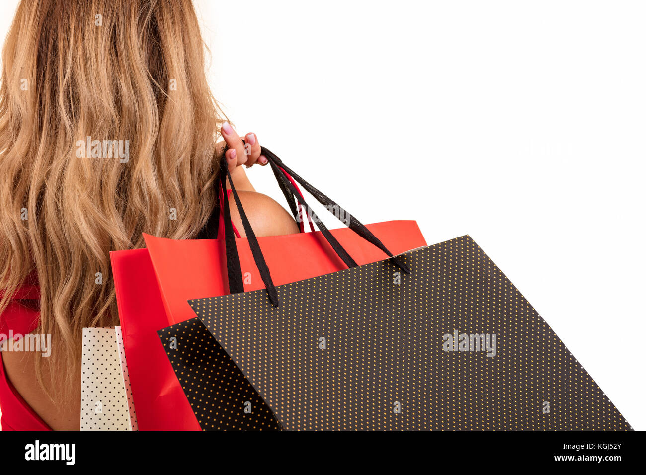 Back view of woman carrying shopping bags on shoulder isolated on white ...