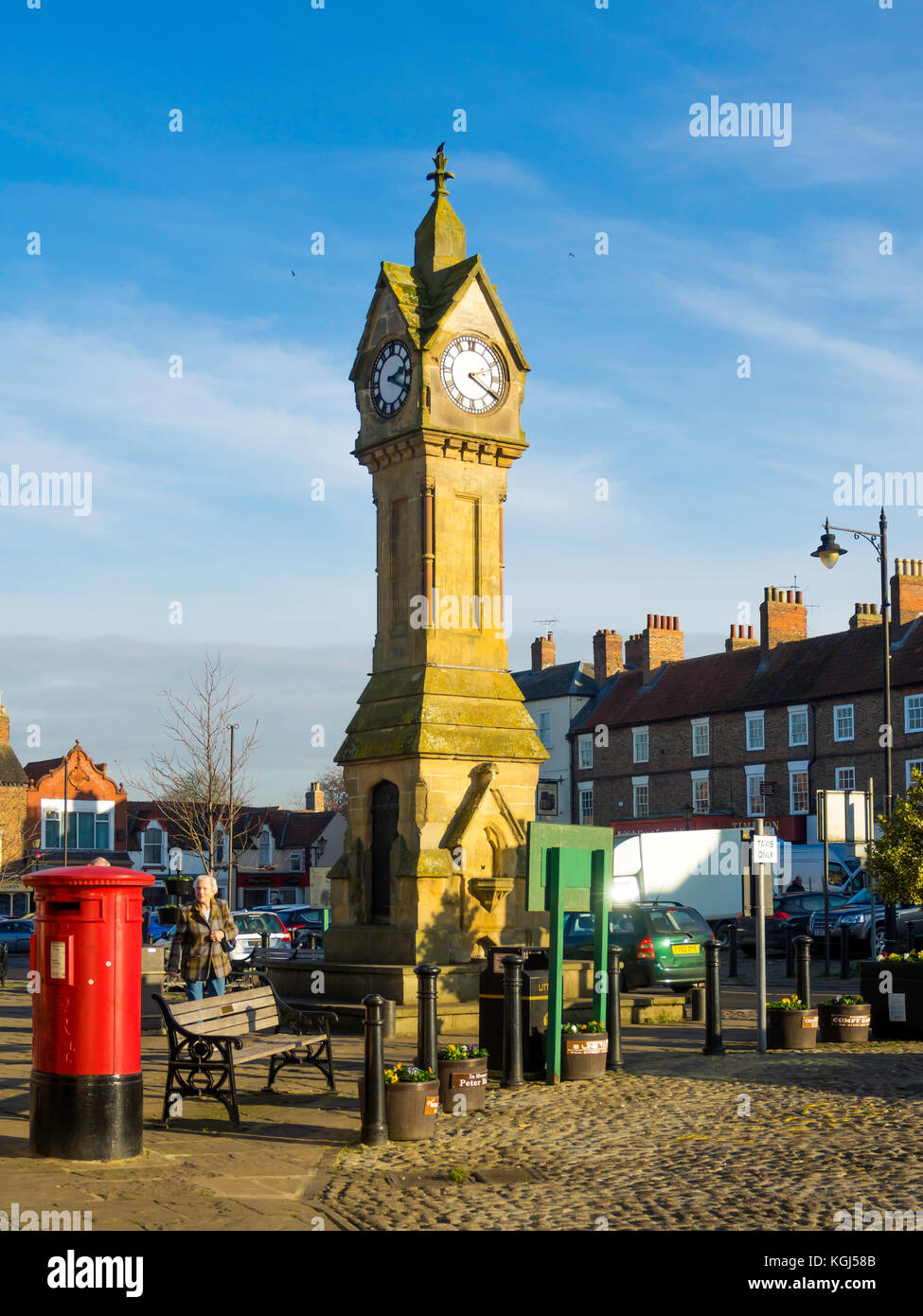 The town clock and a bright red Post Box in the Market Place in Thirsk ...