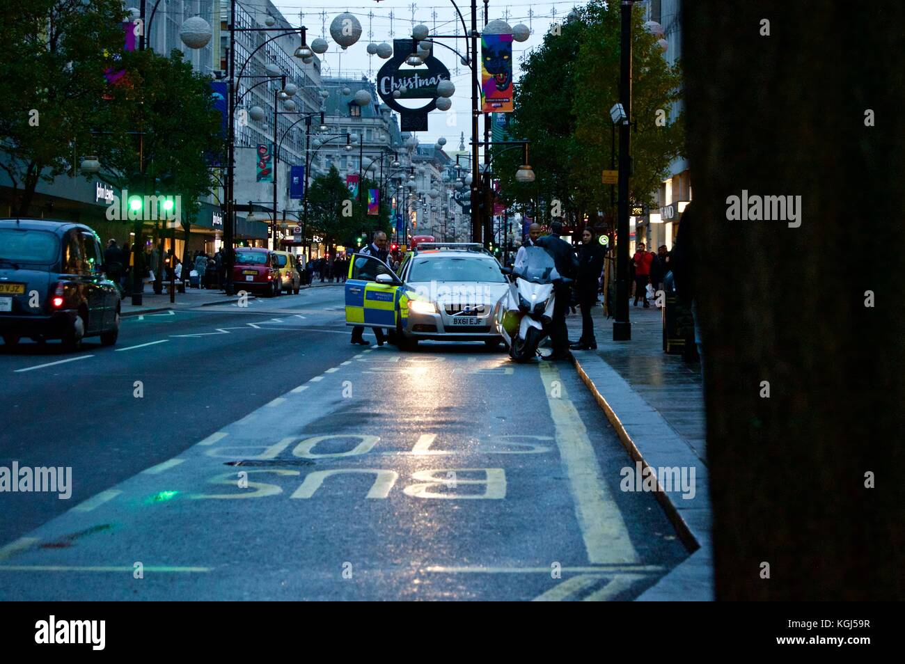 Police car performing traffic stop on motorcycle rider on Oxford Street ...