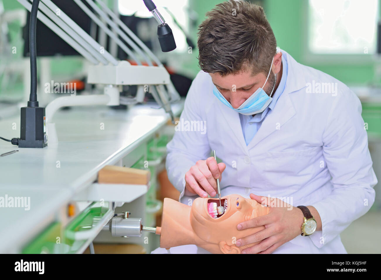 Male dental student practicing on doll in modern clinic Stock Photo - Alamy
