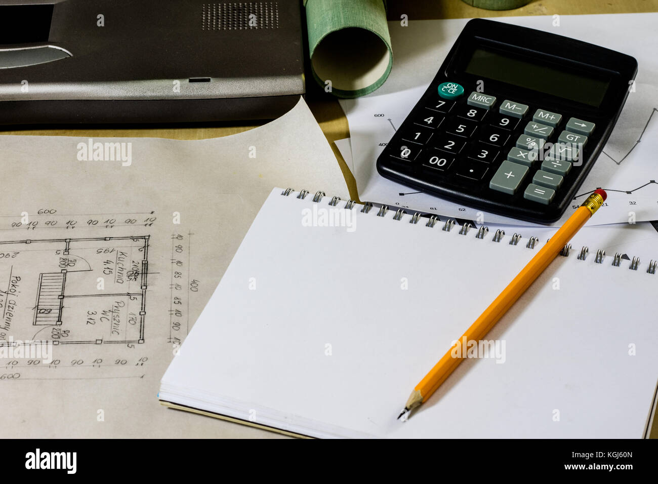 architect's table, laptop, calculator on the table. Plans, projects and ...