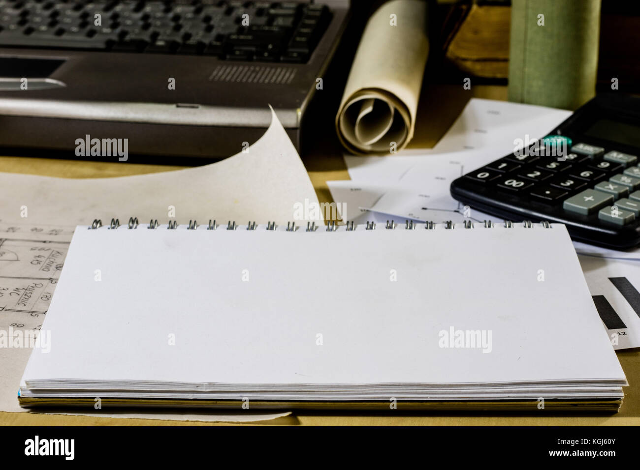 architect's table, laptop, calculator on the table. Plans, projects and ...