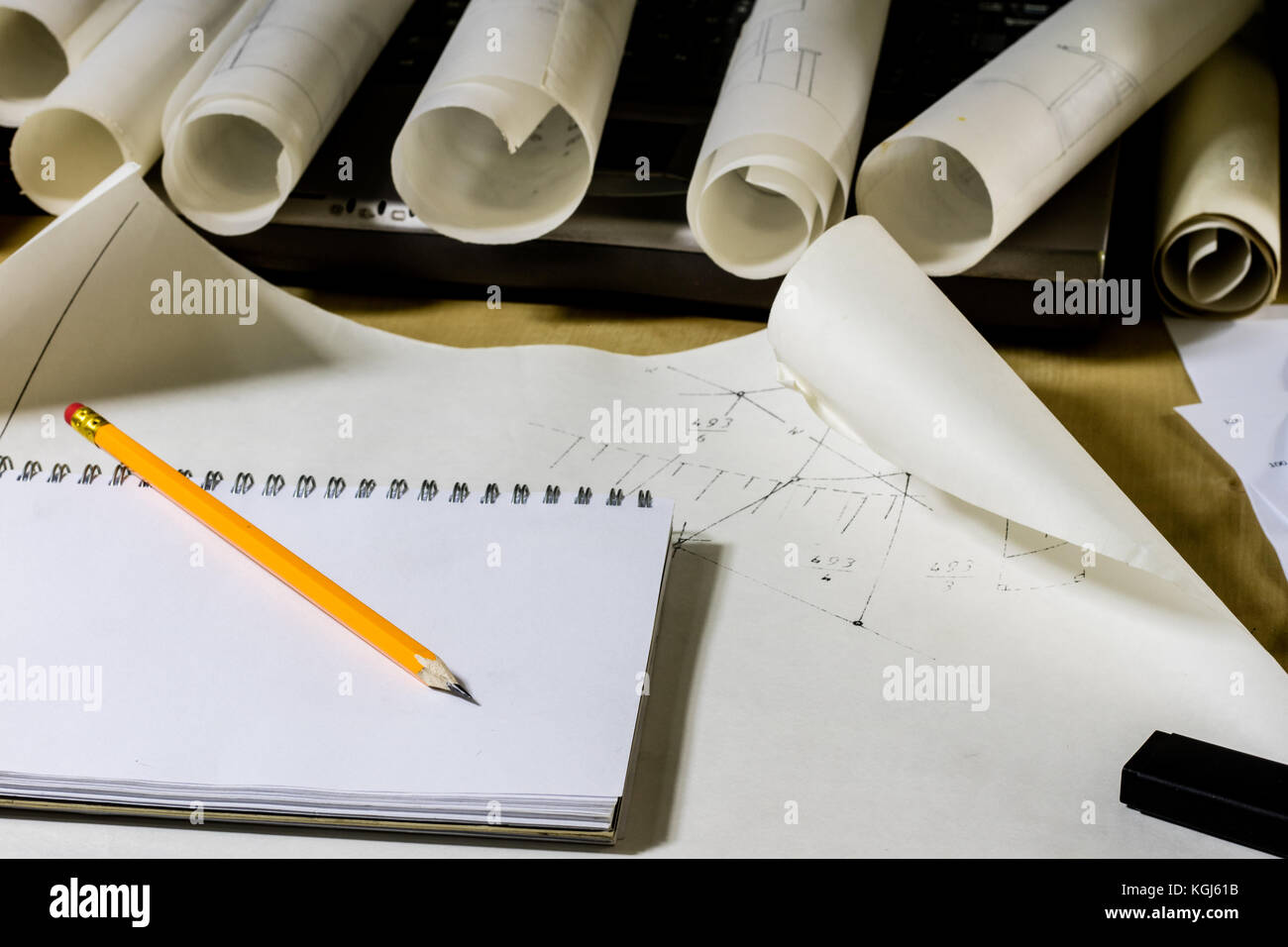 architect's table, laptop, calculator on the table. Plans, projects and ...