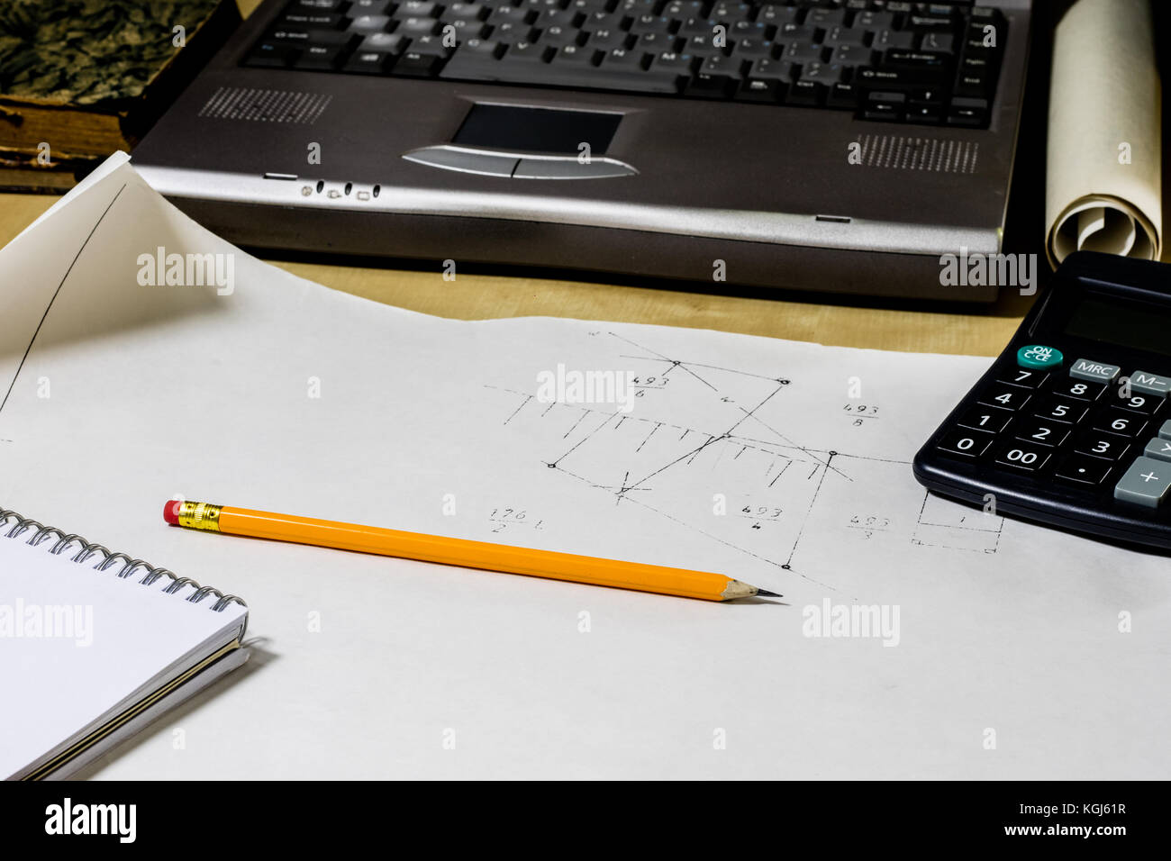 architect's table, laptop, calculator on the table. Plans, projects and ...