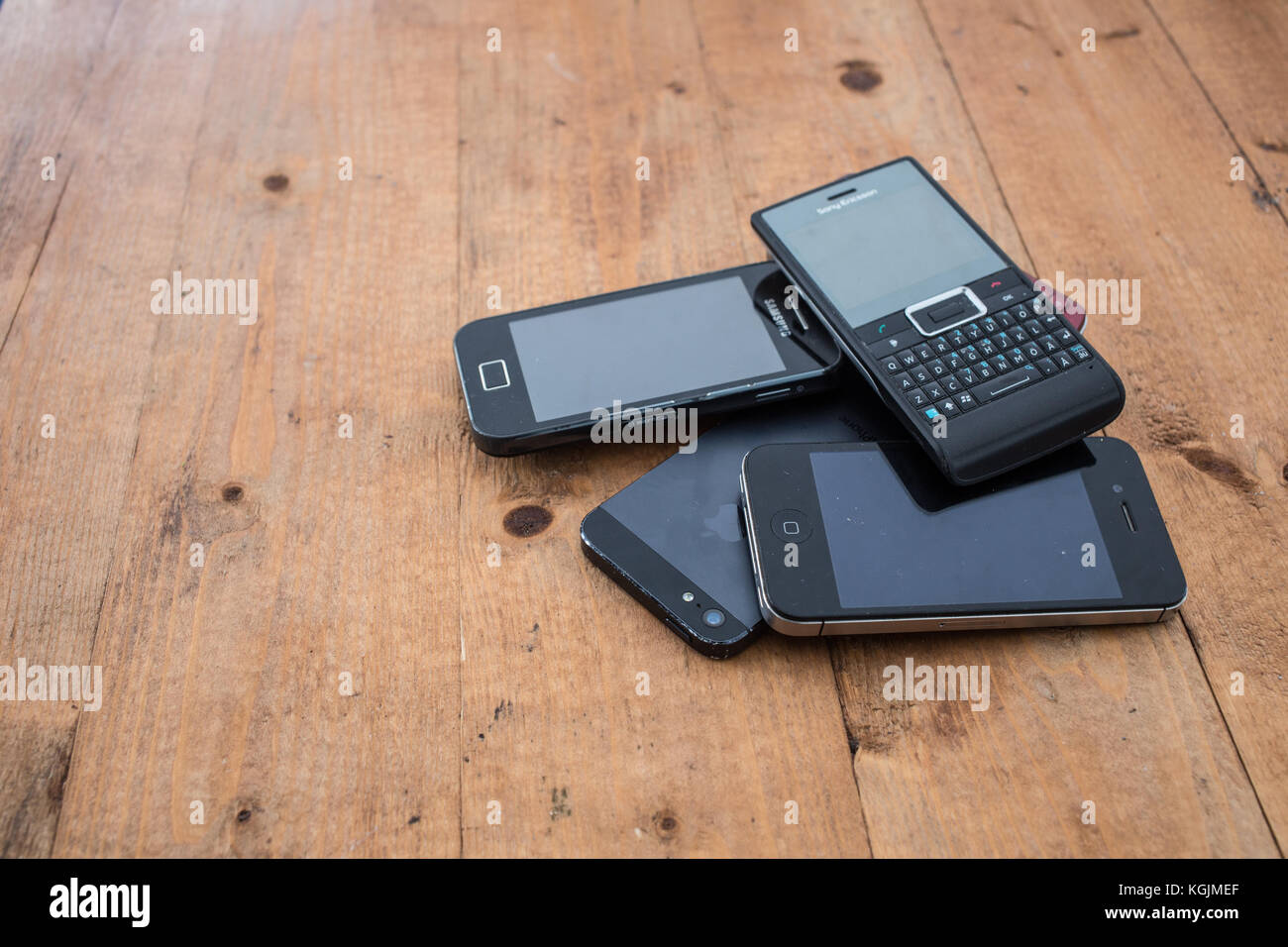 Smartphones laying on a table Stock Photo - Alamy