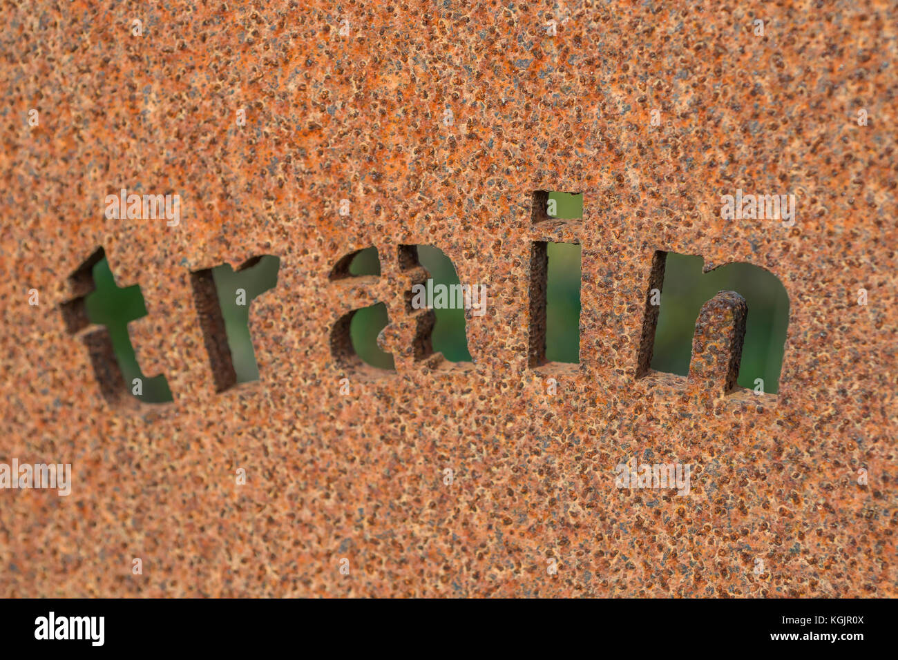 Close-up of the word 'train' cut into the rusty metalwork of a ...