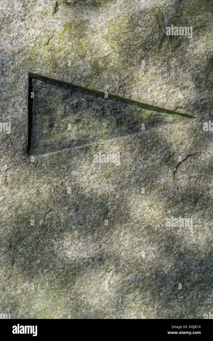 Directional arrow carved into a stone block on a country walk. Metaphor ...