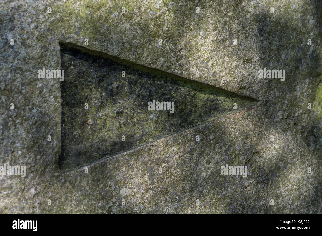 Directional arrow carved into a stone block on a country walk. Metaphor ...