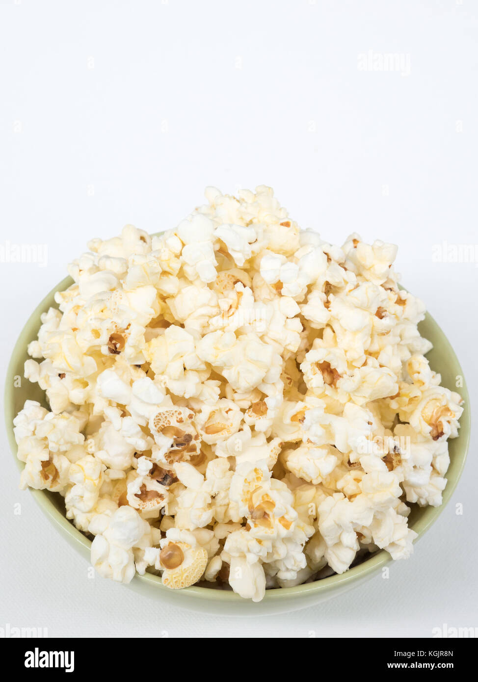 Butter popcorn in the green ceramic bowl for enjoy in the movie time at ...