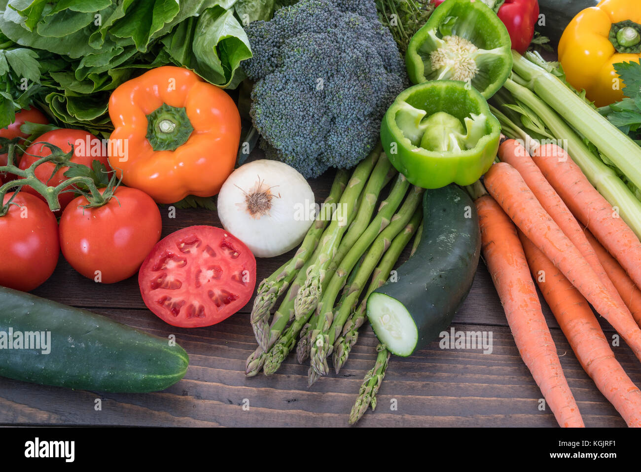 Assorted fresh raw vegetables on a rustic wood table Stock Photo - Alamy