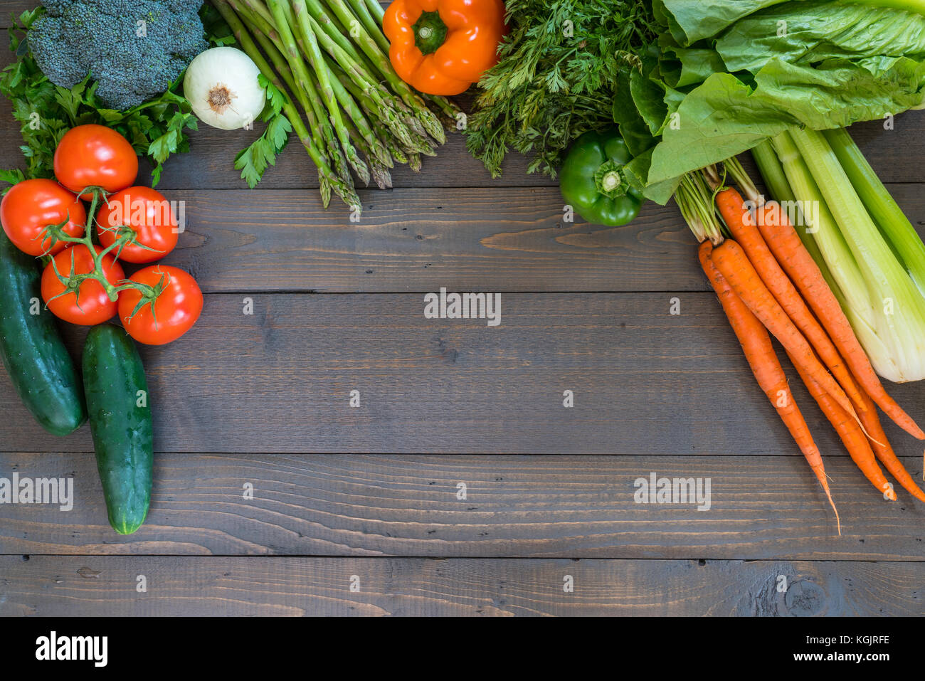 Assorted fresh raw vegetables on a rustic wood table Stock Photo - Alamy