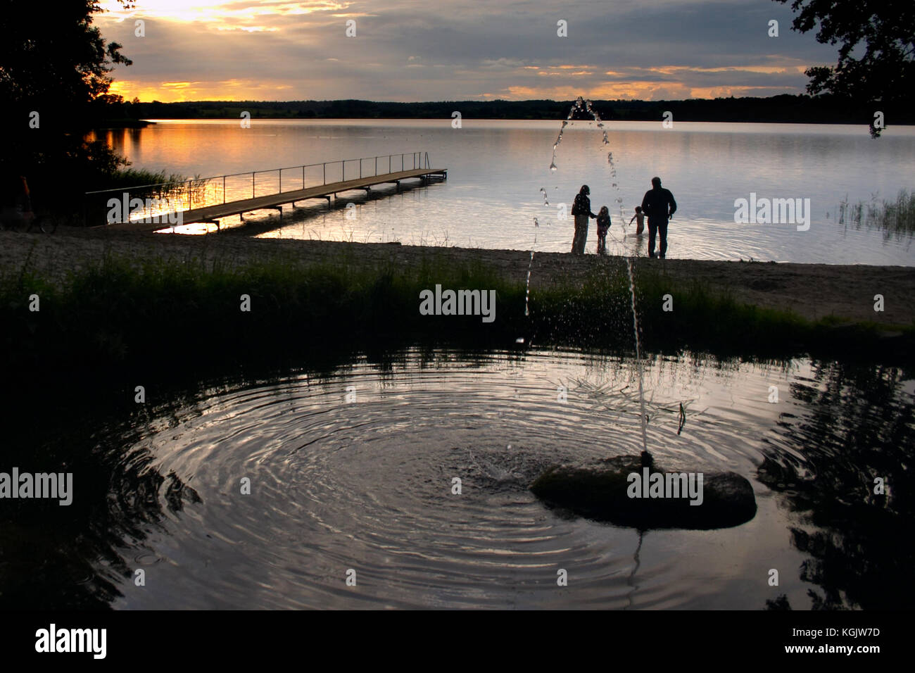 a lake in denmark , a so called bath bridge on a danish lake A family ...