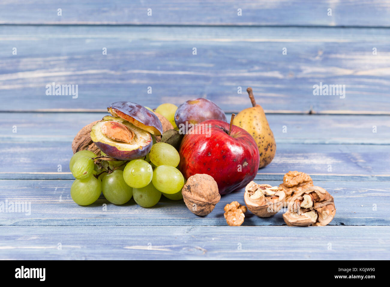Fresh autumn fruits on wood background as organic and natural fall ...