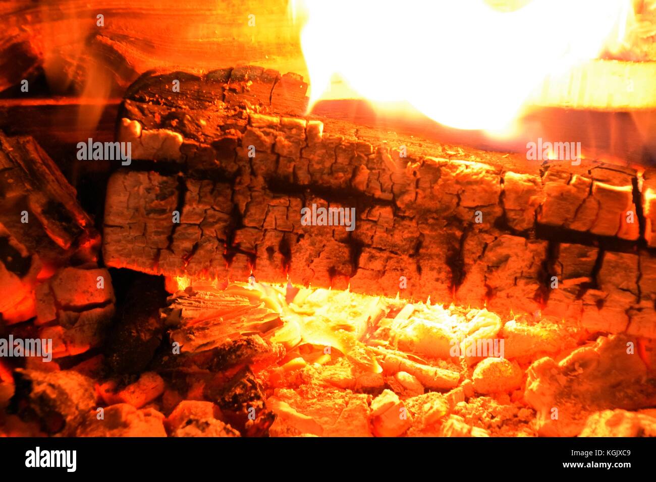burning wood in a tiled stove with hot blazing flames Stock Photo - Alamy