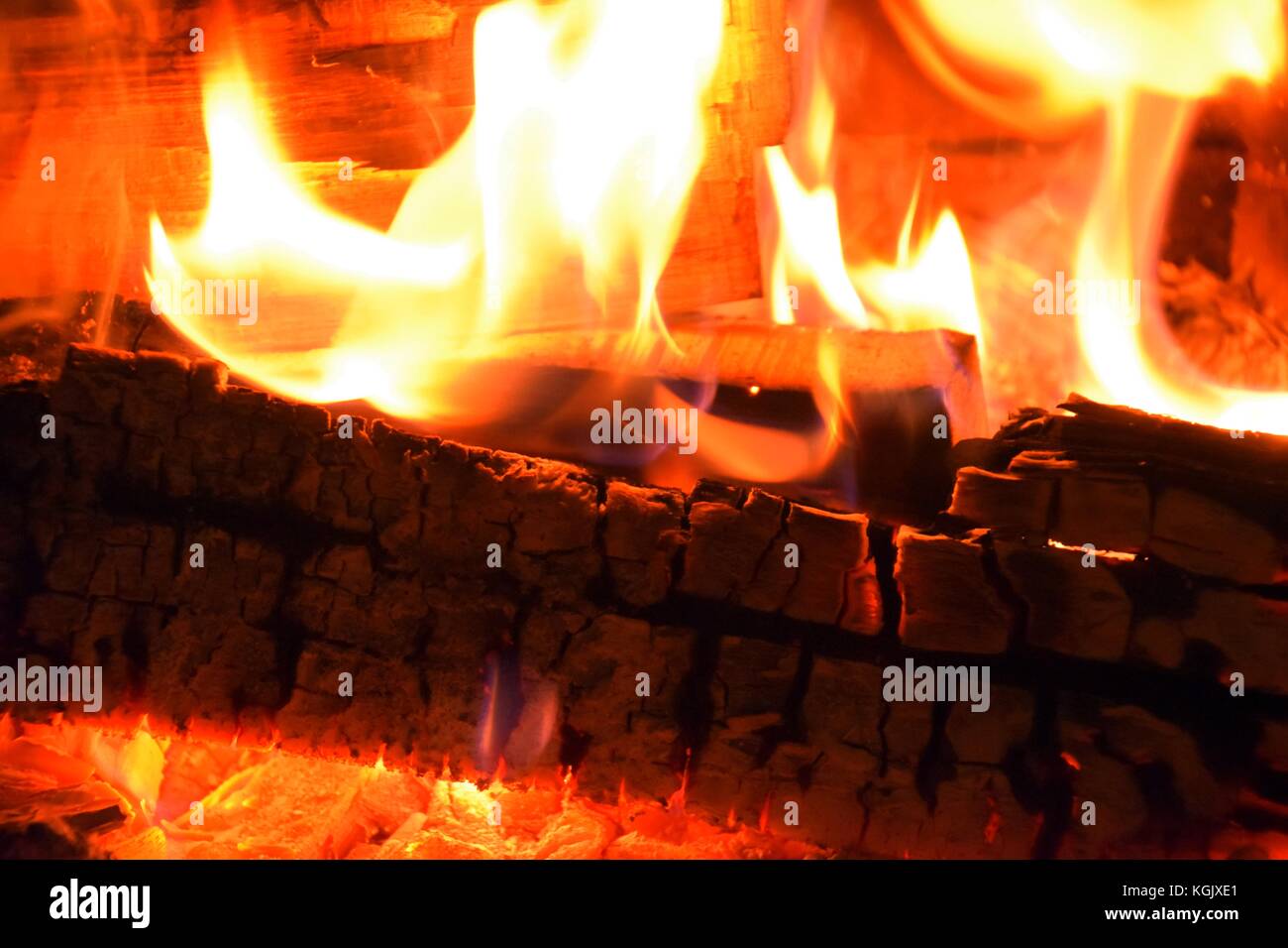 burning wood in a tiled stove with hot blazing flames Stock Photo - Alamy