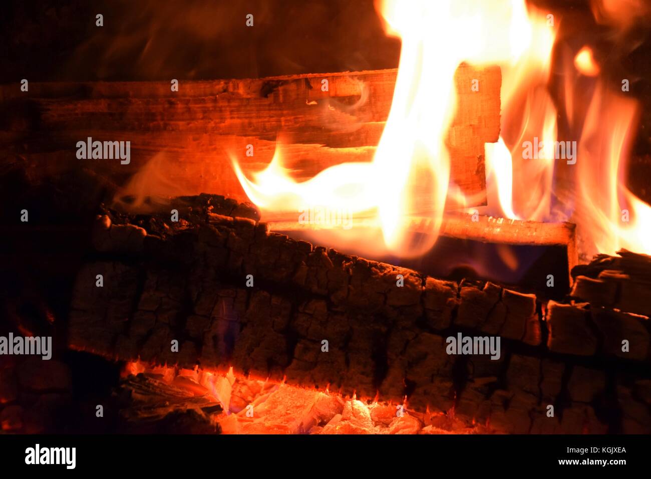 burning wood in a tiled stove with hot blazing flames Stock Photo - Alamy
