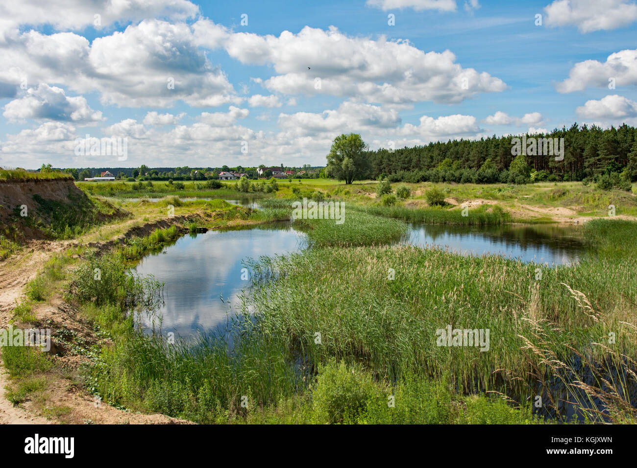 Clay pit ponds with sky reflection on a sunny day Stock Photo - Alamy