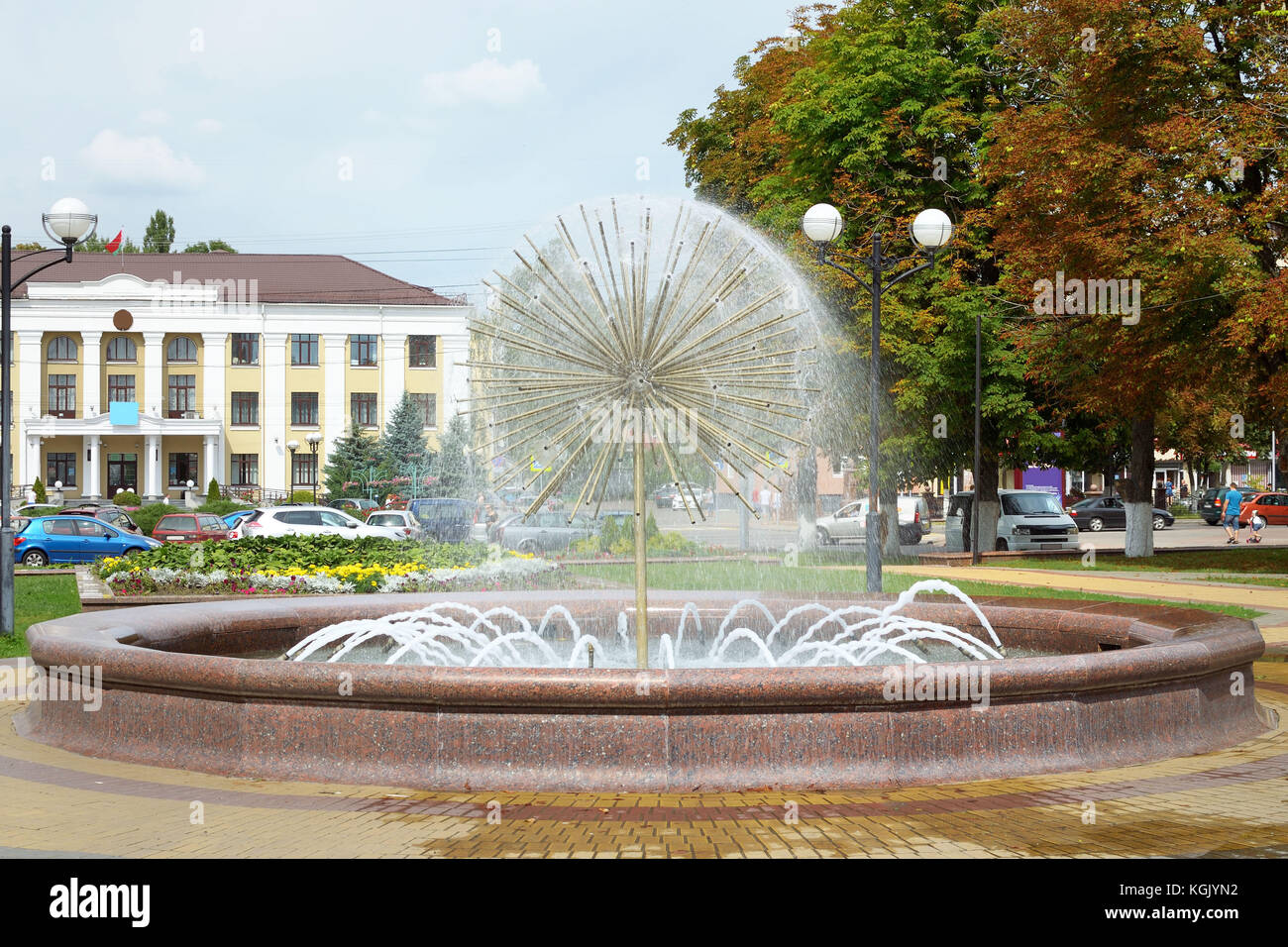 The beautiful circular fountain in the town square Stock Photo - Alamy
