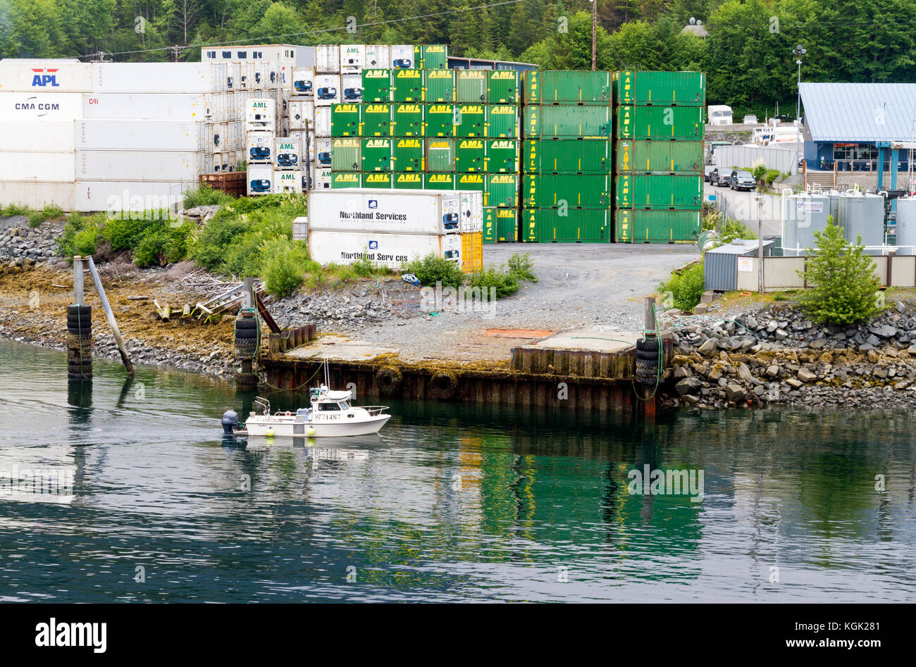 A small boat approaching a pier in Sitka, Alaska where many shipping ...