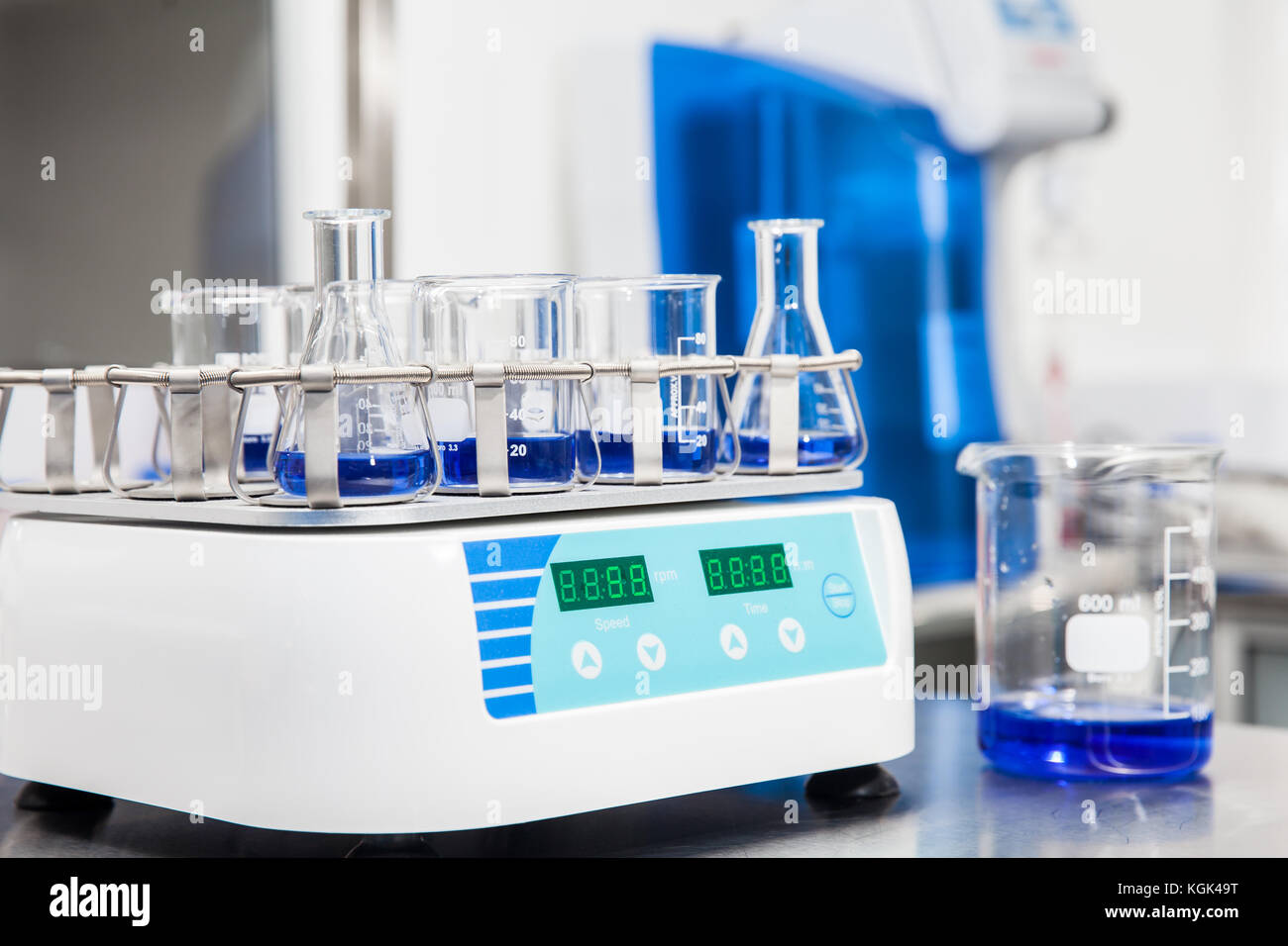 Laboratory shaker loaded with erlenmeyers and beakers Stock Photo - Alamy