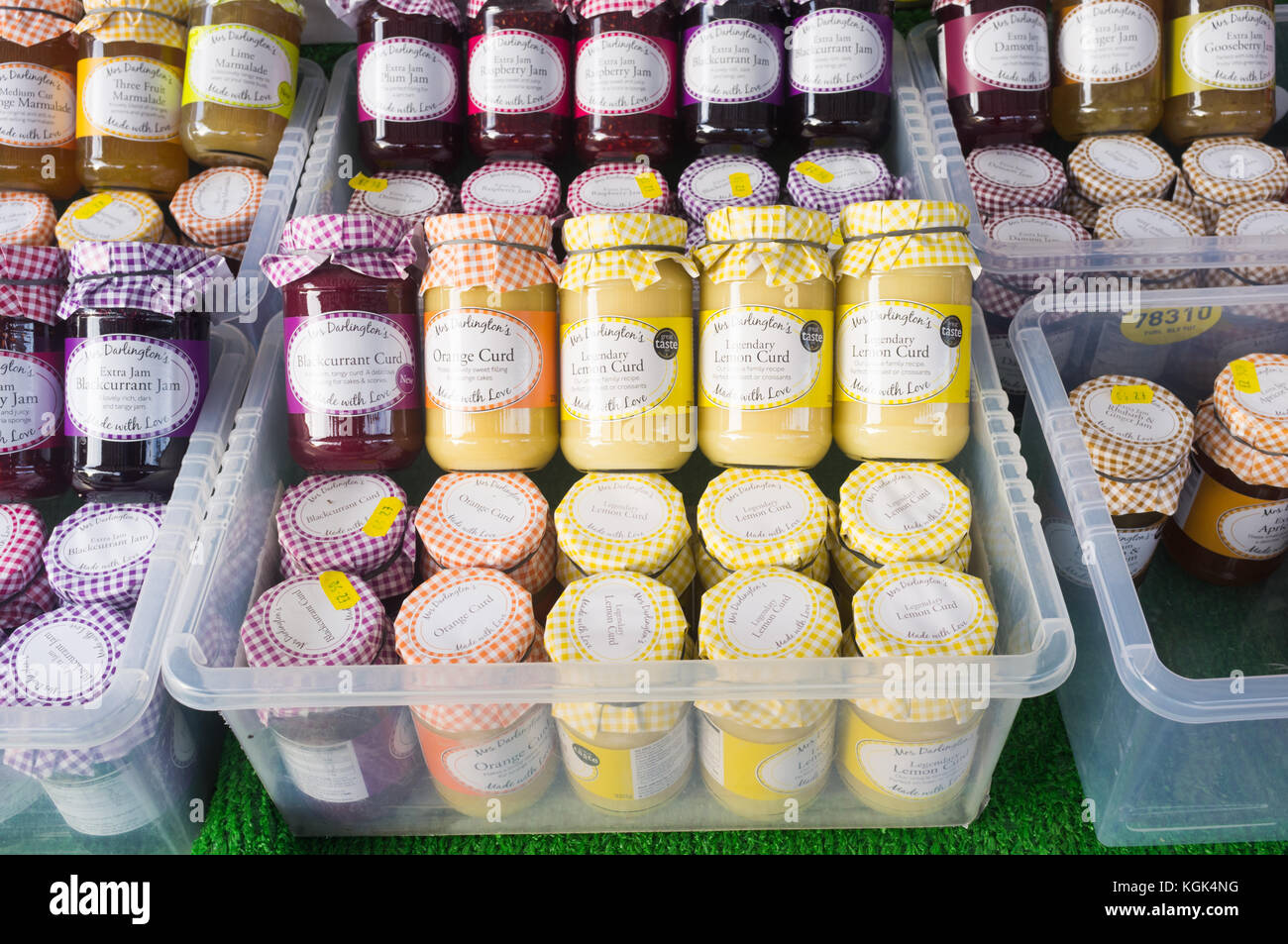 Jars of curd and jam looking traditionally hand made on a market stall ...