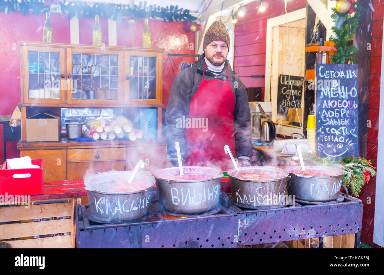 KIEV, UKRAINE - JANUARY 4, 2017: The merchant at market stall offers ...
