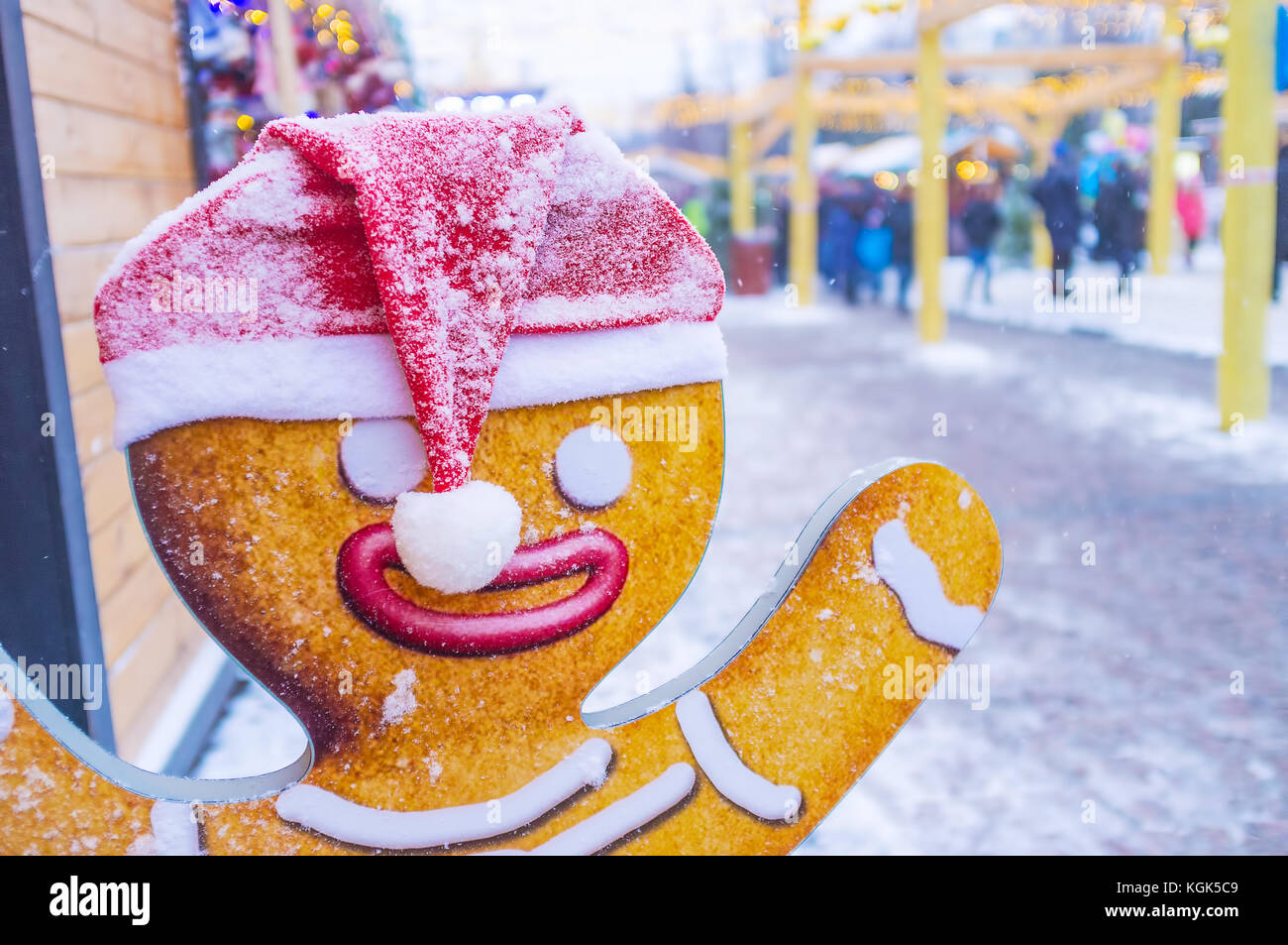 Big gingerbread man in Santa Claus' hat attracts visitors to toy stall ...