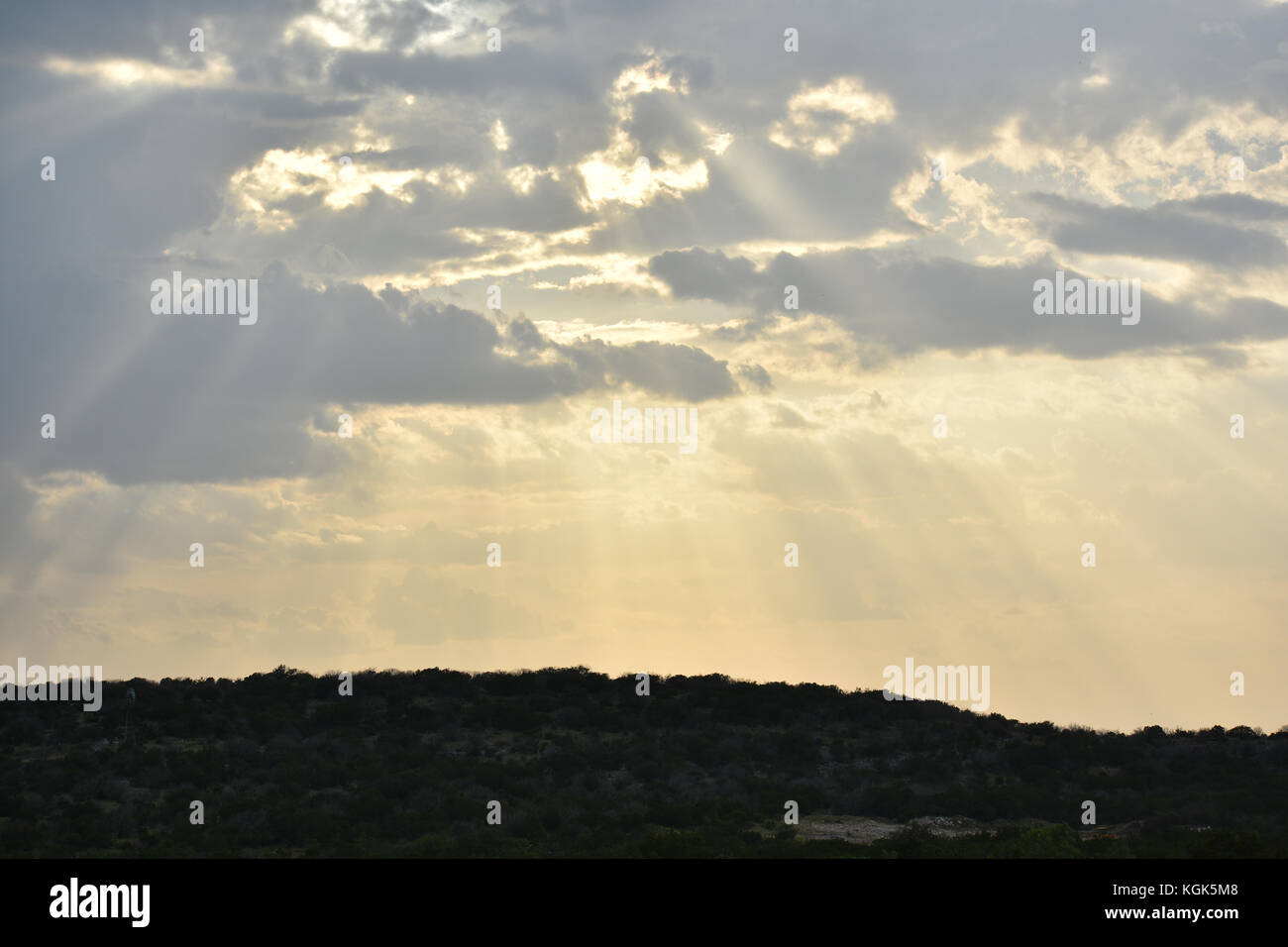 Sun Rays Shining Through The Clouds Stock Photo - Alamy